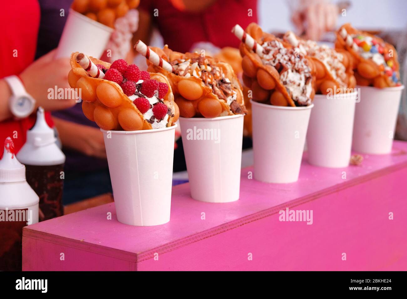 Bubble waffles with raspberries, chocolate and marshmallow in white ...