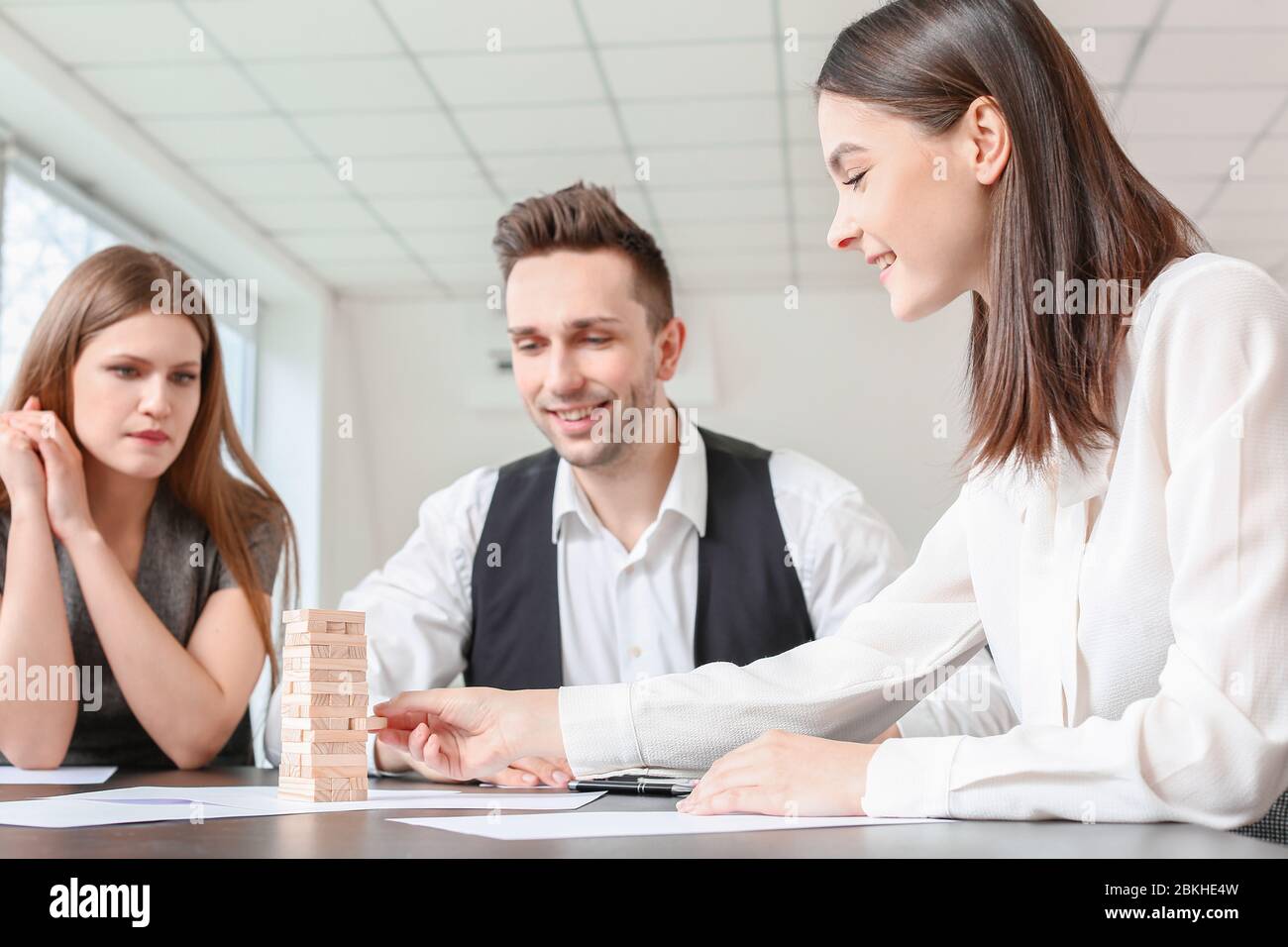 Team of business people playing jenga in office Stock Photo - Alamy