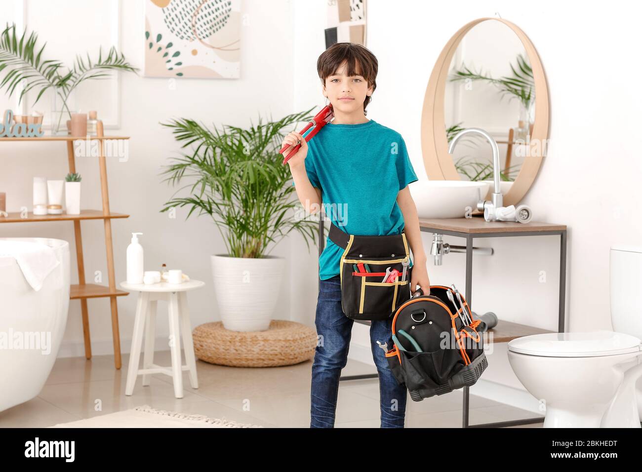 Portrait of little plumber in restroom Stock Photo - Alamy