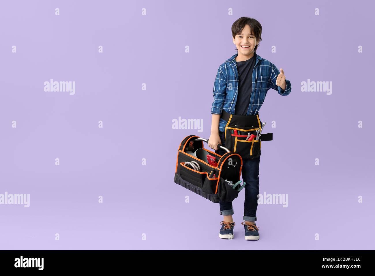 Portrait of little plumber on color background Stock Photo - Alamy
