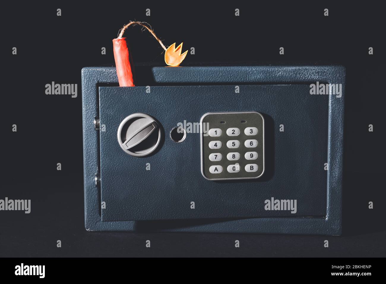 Modern safe with dynamite on dark background Stock Photo - Alamy