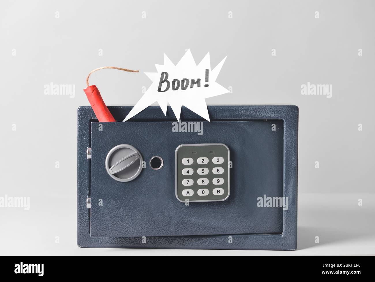 Modern safe with dynamite on light background Stock Photo - Alamy
