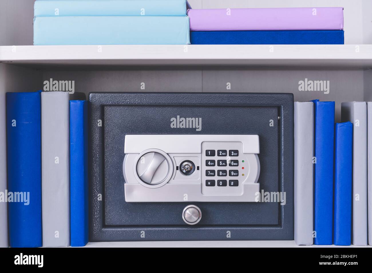 Modern safe on shelf in office Stock Photo - Alamy