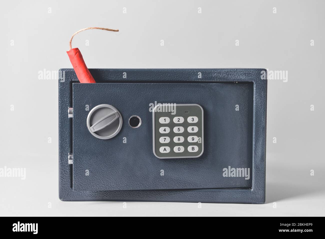Modern safe with dynamite on light background Stock Photo - Alamy