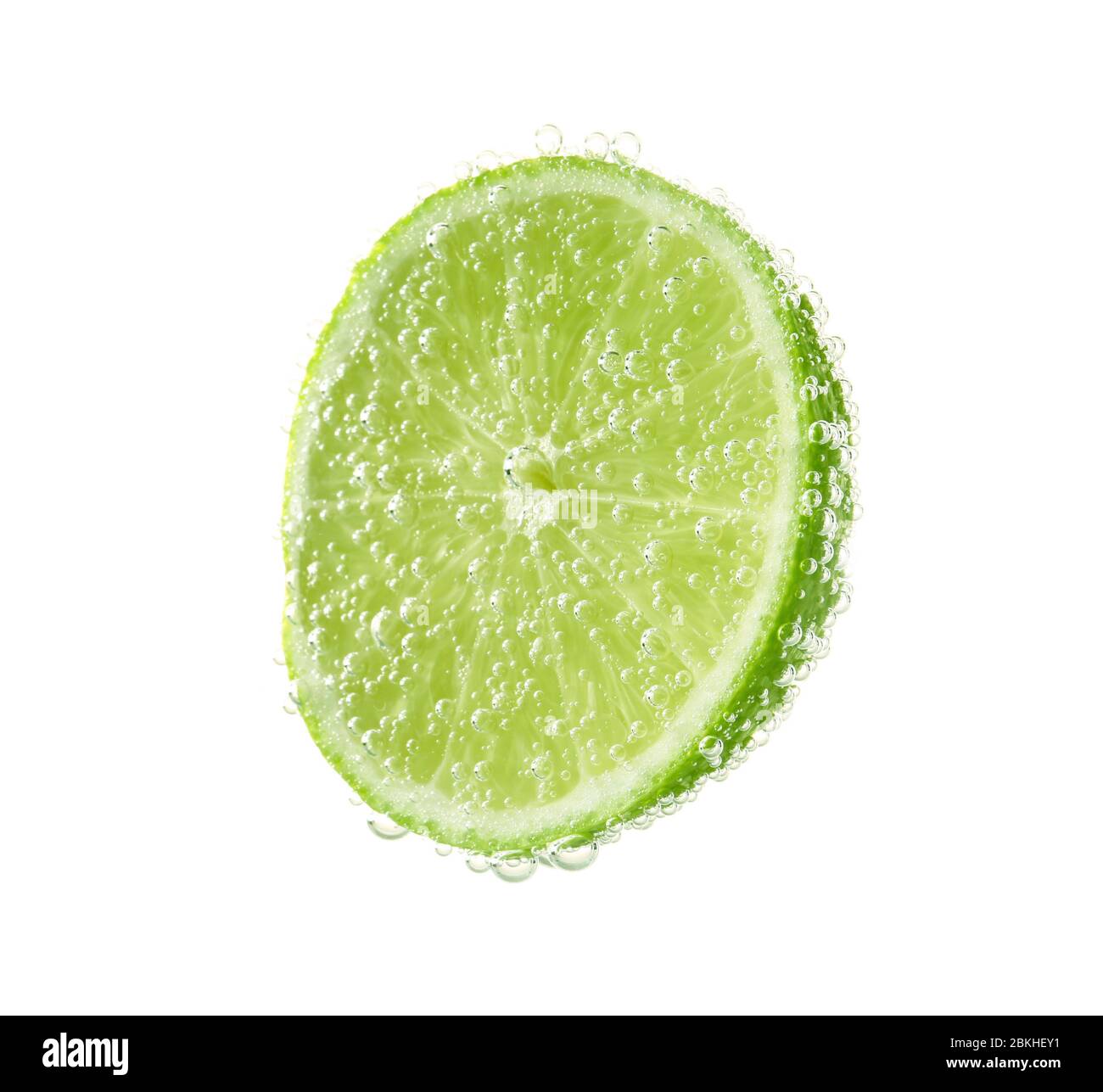 Fresh lime piece under water on white background Stock Photo - Alamy