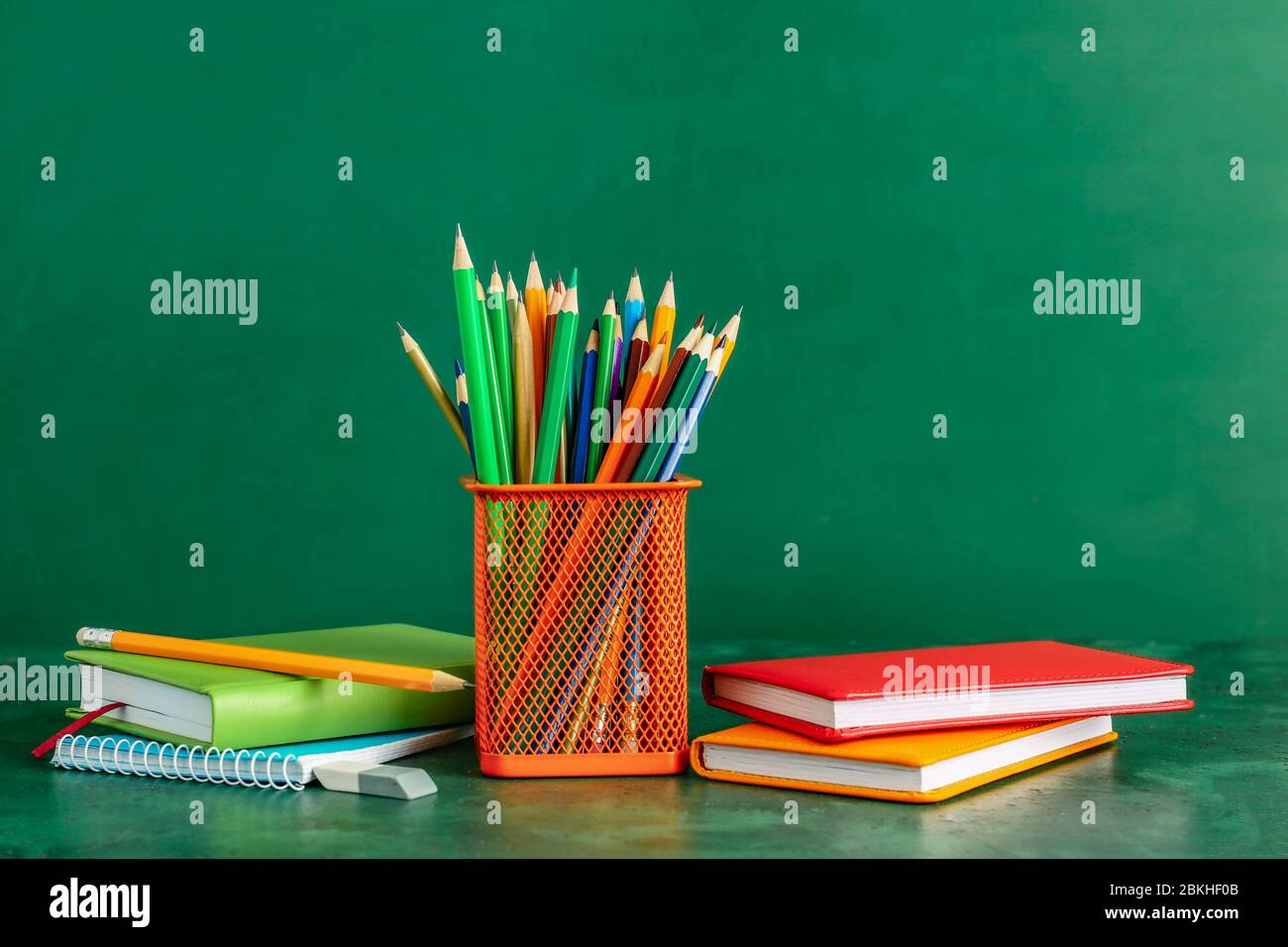 Holder with stationery on color background Stock Photo - Alamy