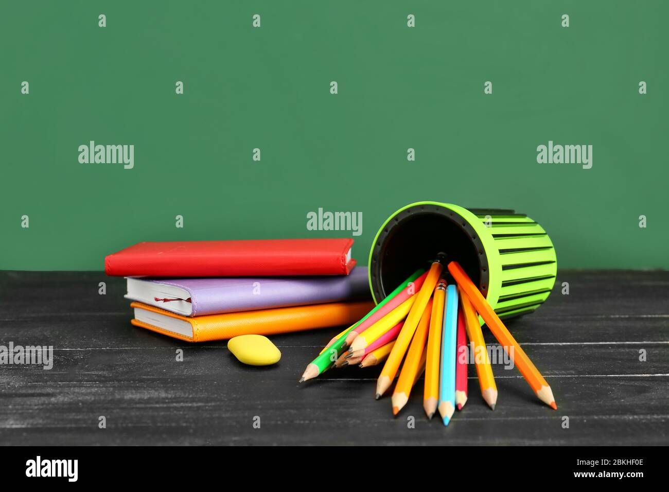 Holder with stationery on table in classroom Stock Photo - Alamy