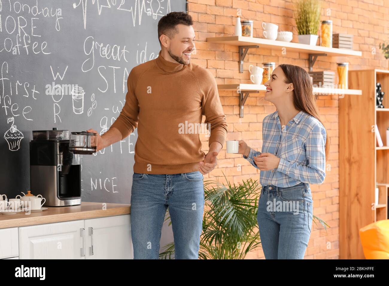 Colleagues drinking coffee in kitchen of office Stock Photo - Alamy