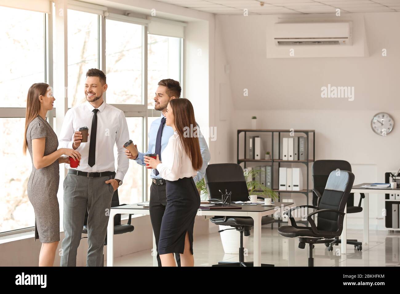 Colleagues drinking coffee in office Stock Photo - Alamy
