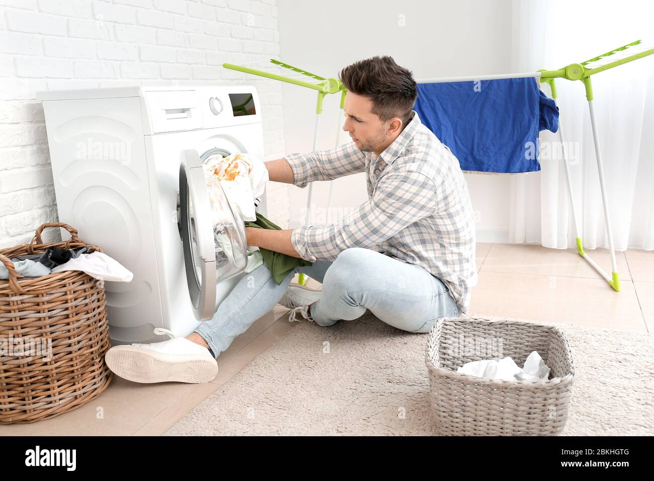 Awkward man sitting hi-res stock photography and images - Alamy