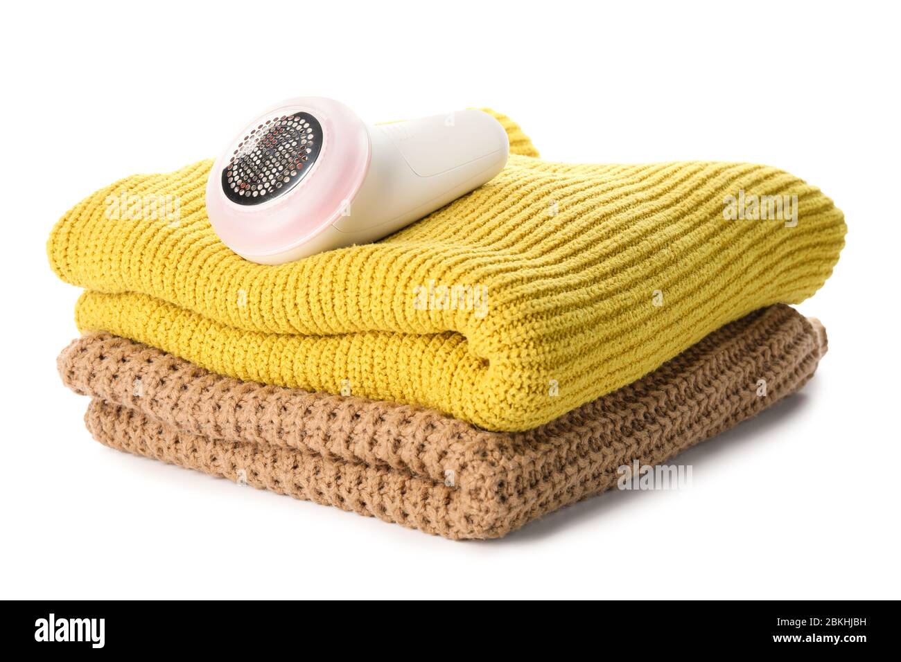Modern fabric shaver and clothes on white background Stock Photo - Alamy