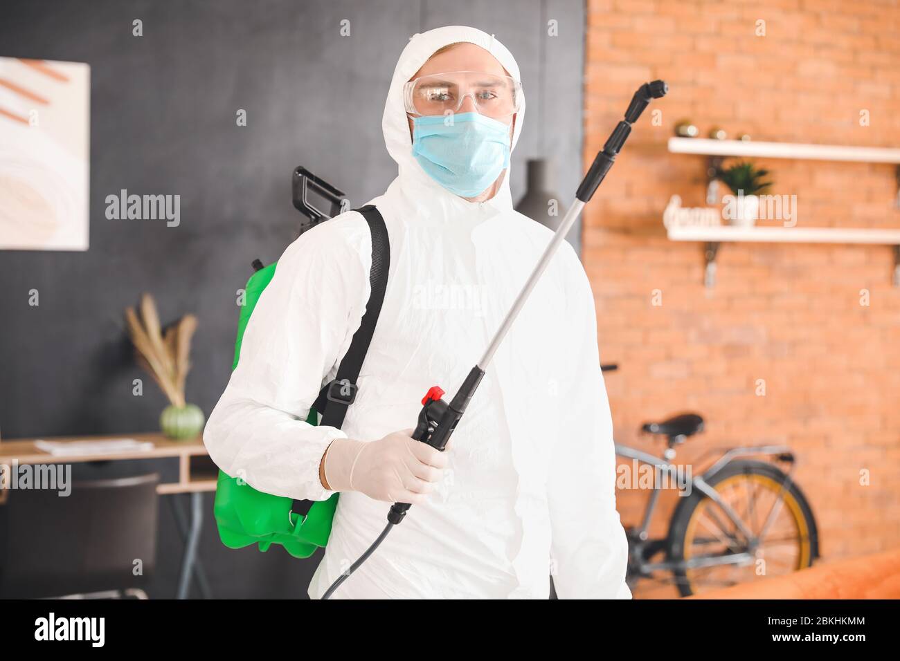Worker in biohazard suit disinfecting house Stock Photo - Alamy