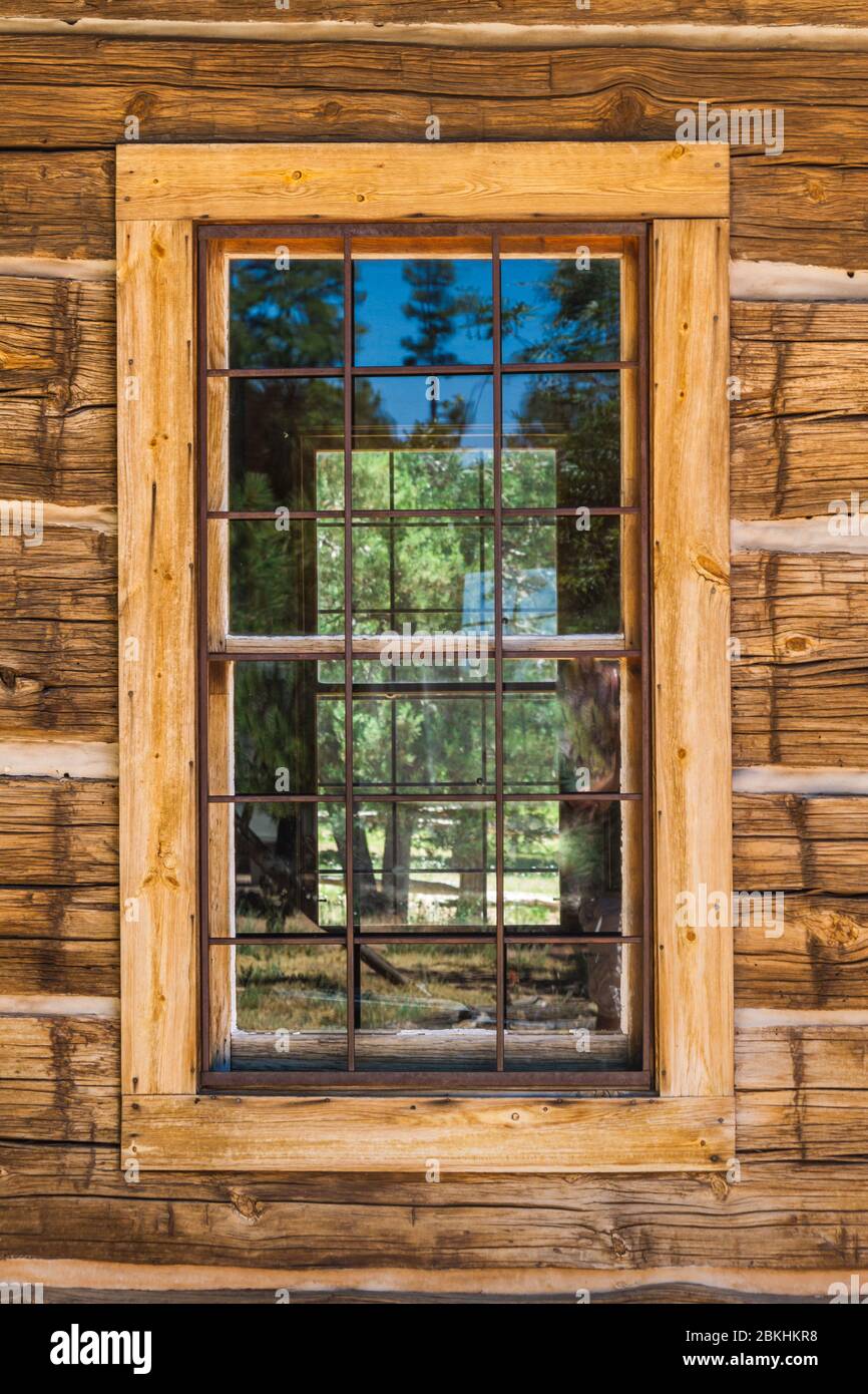 An old window on a rustic cabin with highly textured wood planks ...