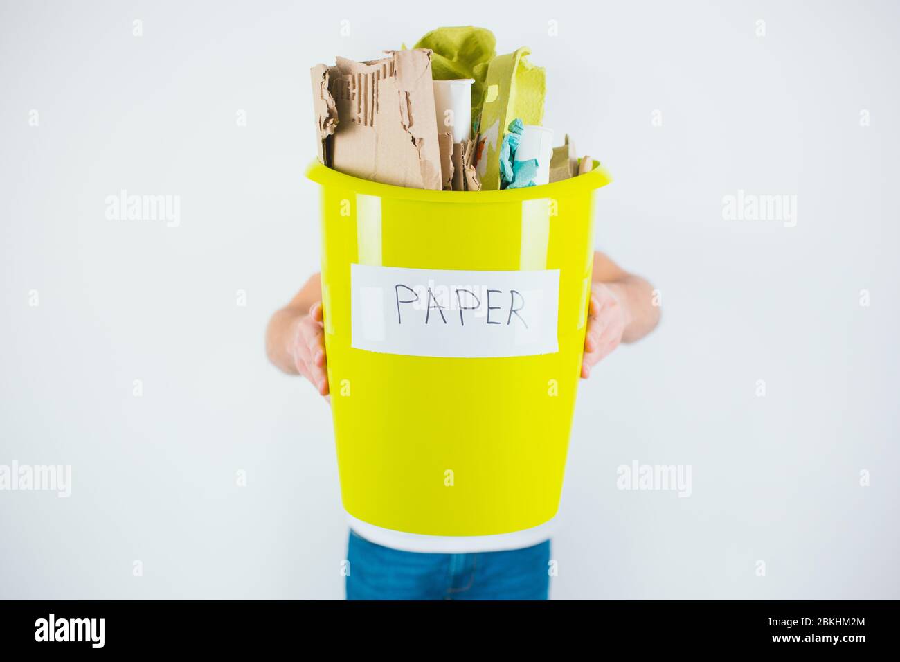 Young man isolated over white background. Guy hold yellow plastic ...
