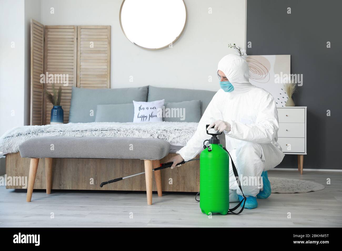 Worker in biohazard suit disinfecting house Stock Photo - Alamy