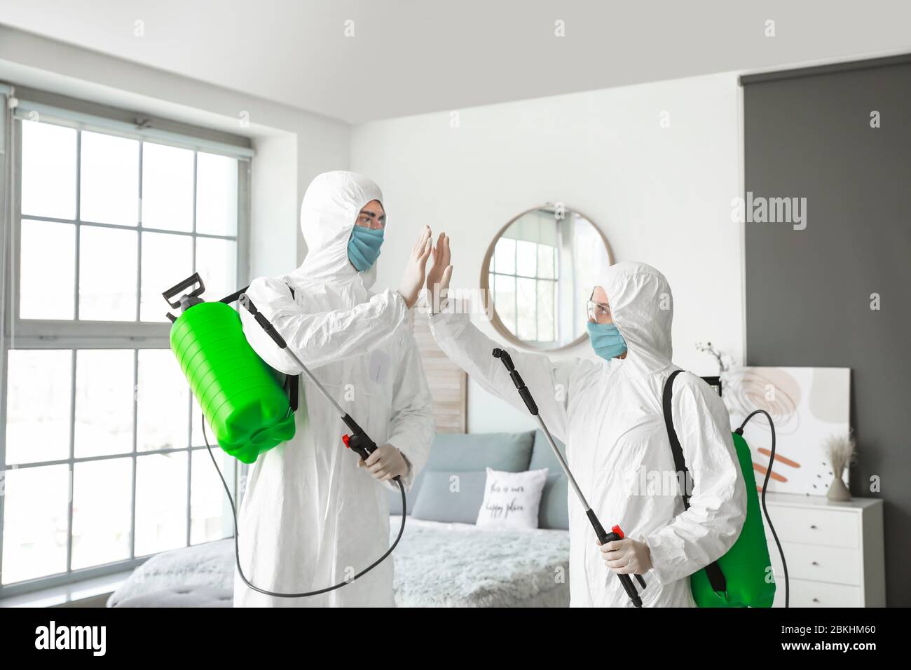 Workers in biohazard suits disinfecting house Stock Photo - Alamy