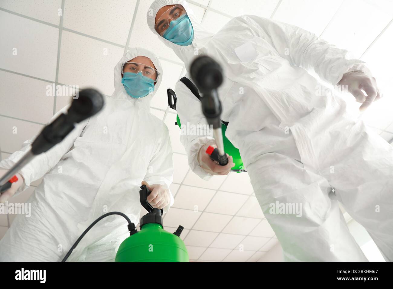 Workers in biohazard suits disinfecting house Stock Photo - Alamy