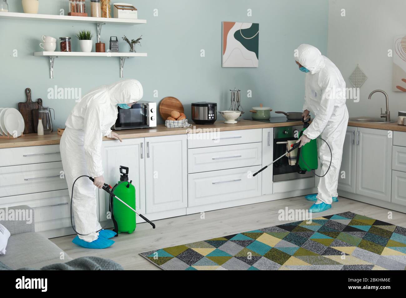 Workers in biohazard suits disinfecting house Stock Photo - Alamy