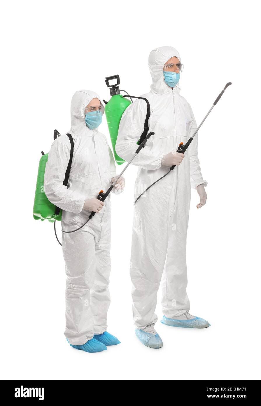 Workers in biohazard suits and with disinfectant on white background ...