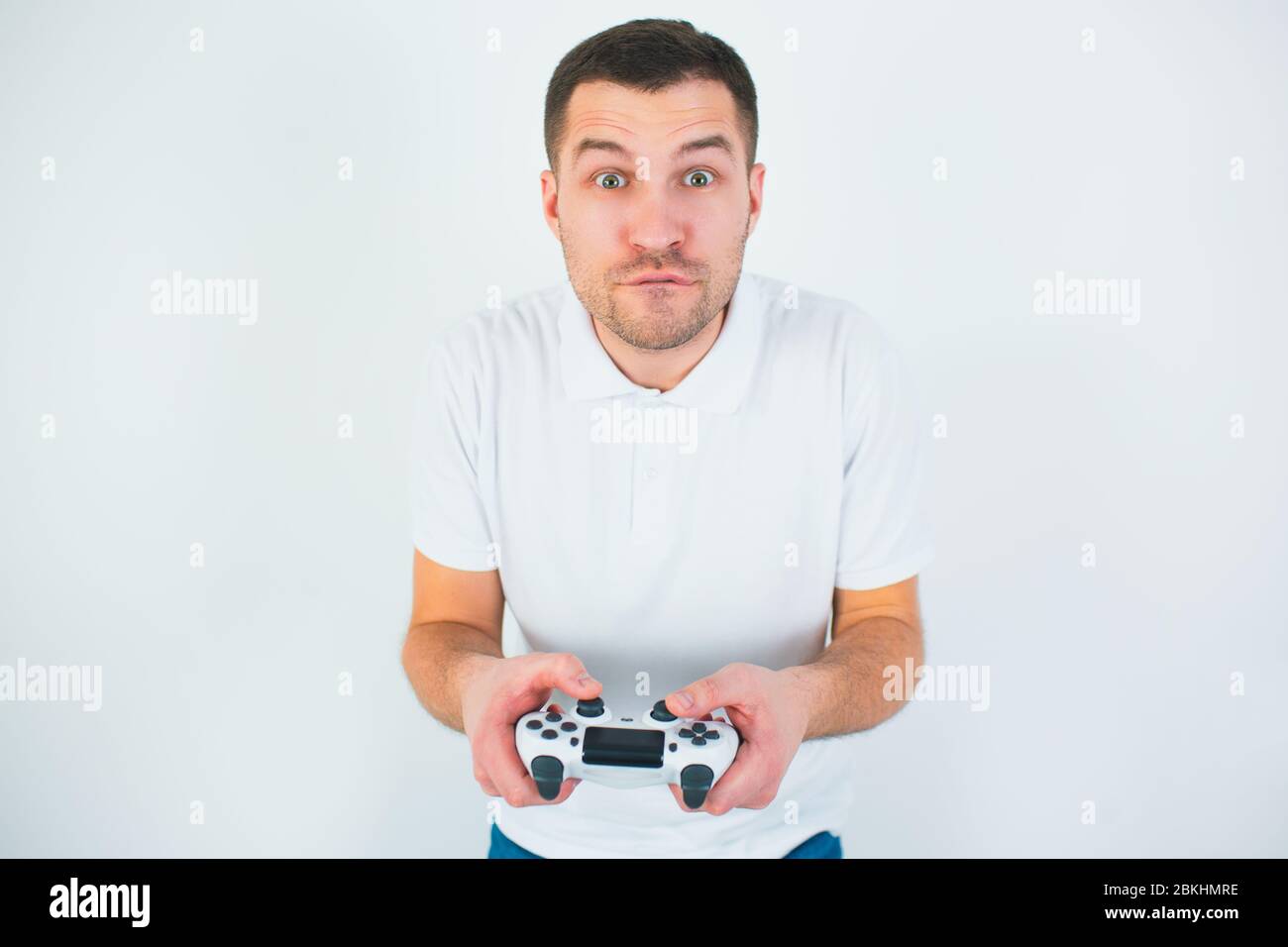 Young man isolated over white background. Guy hold joystick in hands ...