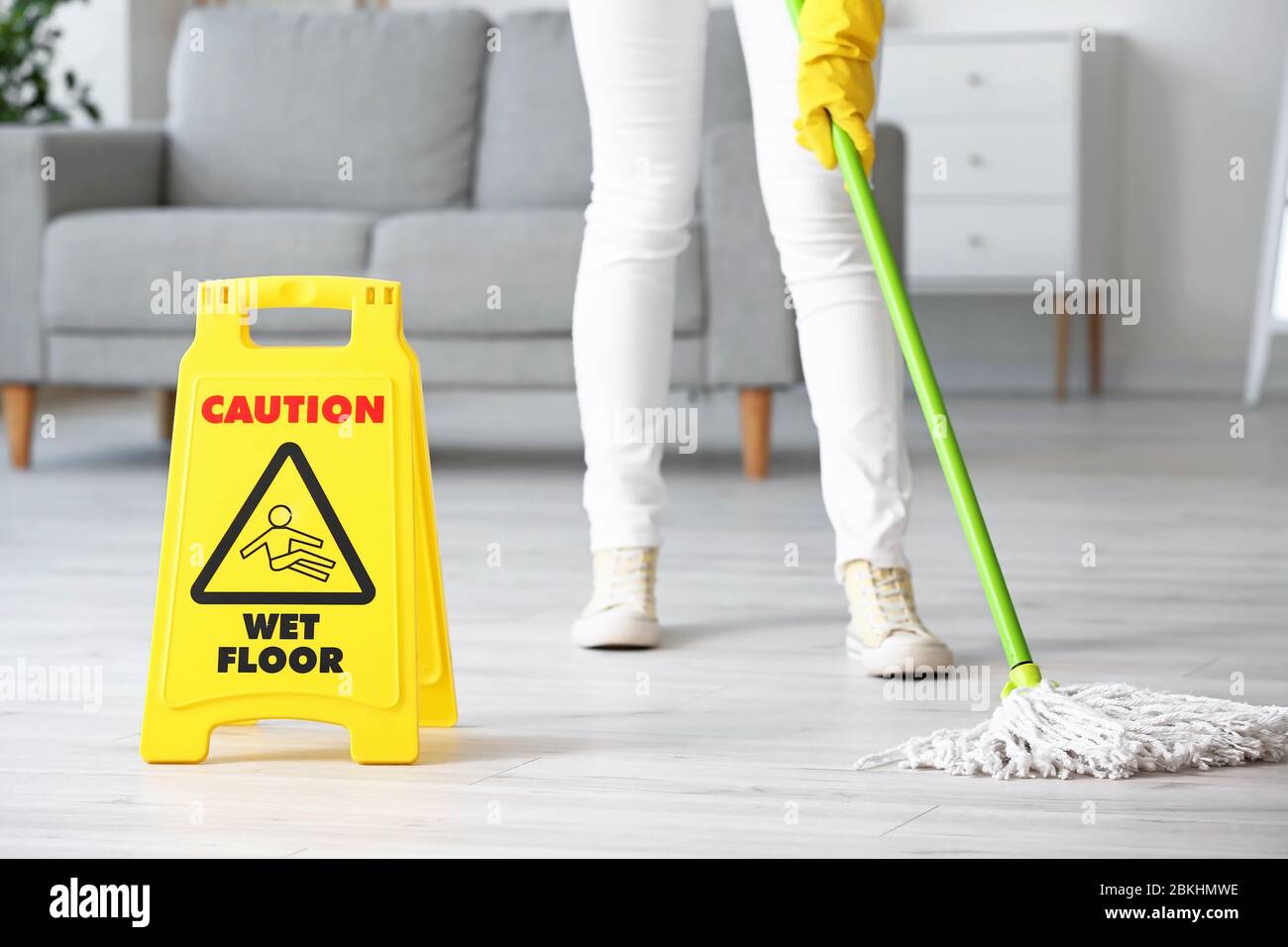 Young woman mopping floor in room Stock Photo - Alamy
