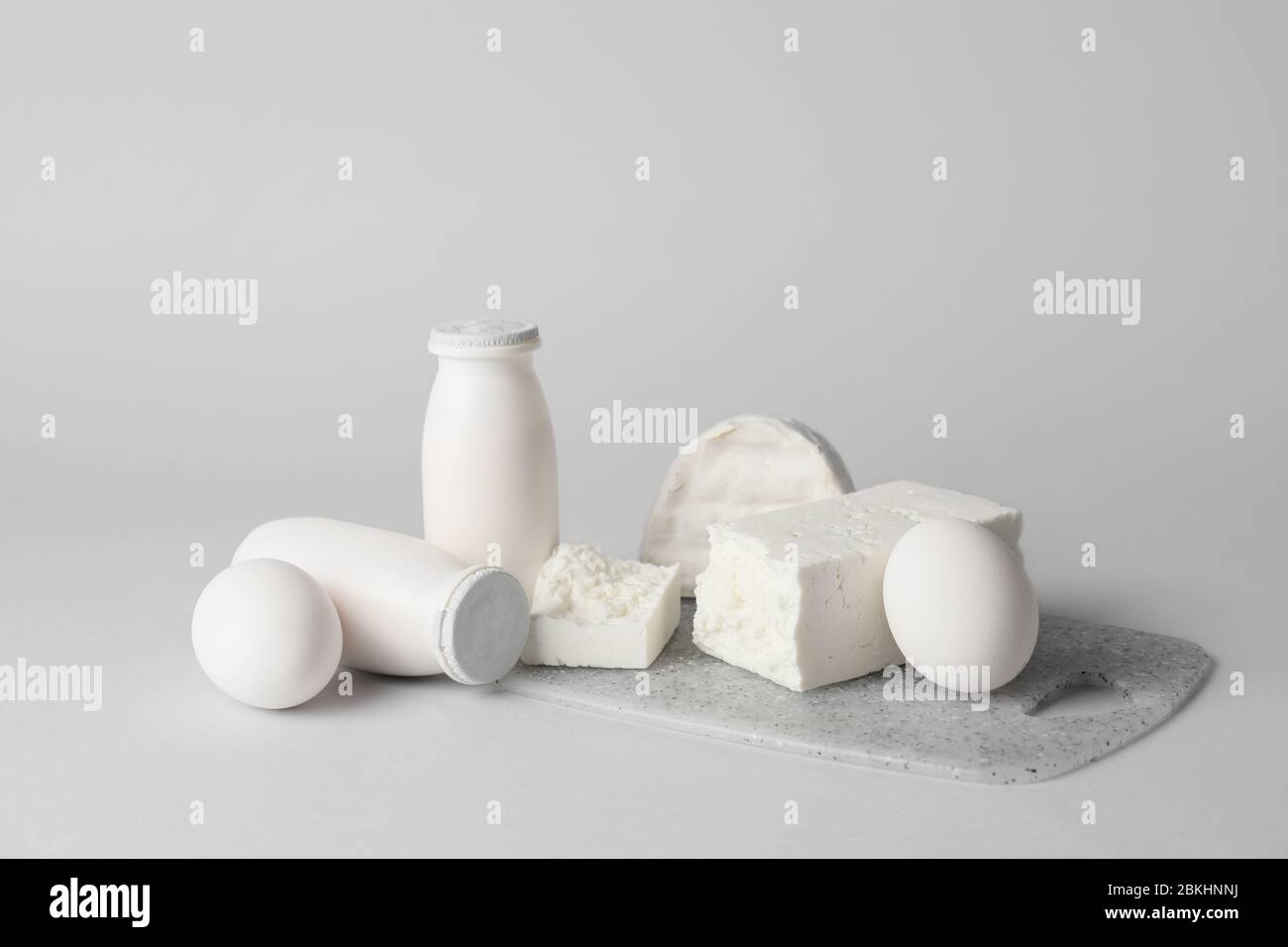 Different dairy products without lactose on grey background Stock Photo ...