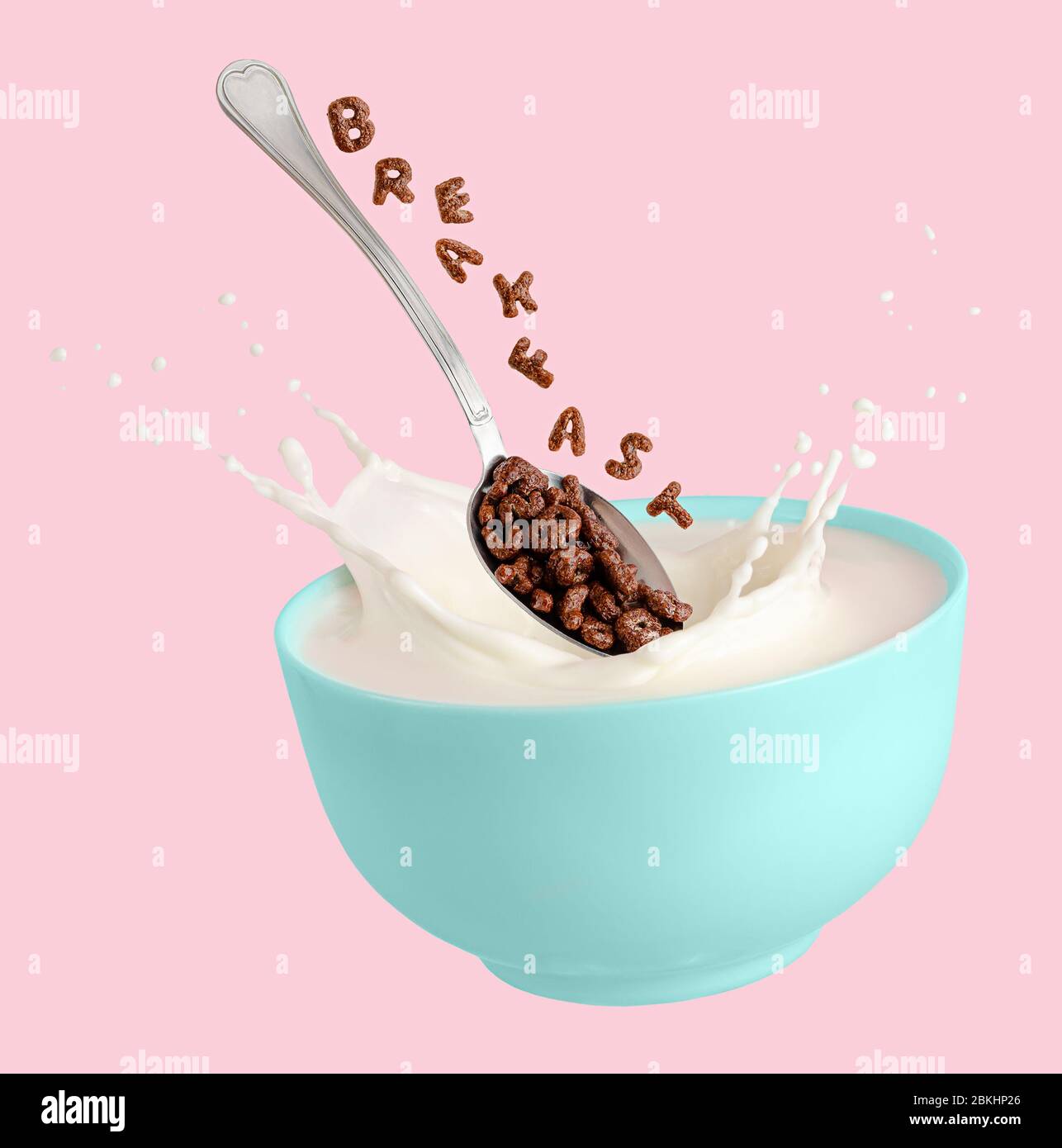 Cocoa cereal letters falling into blue bowl with splashing milk ...