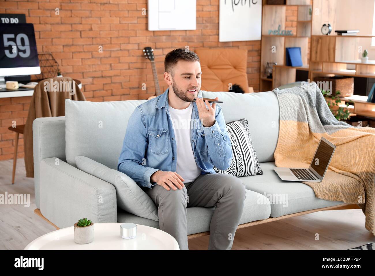 Man with mobile phone in room. Modern technology and smart home ...