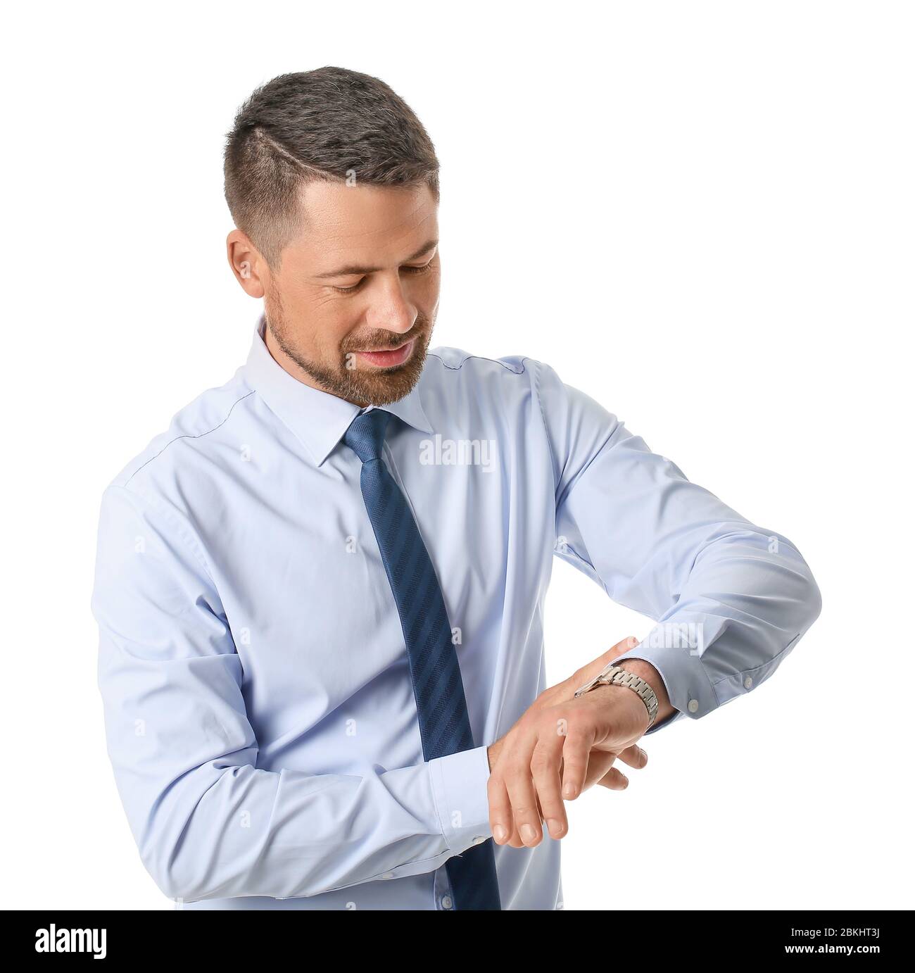Portrait of handsome businessman looking at his watch on white ...