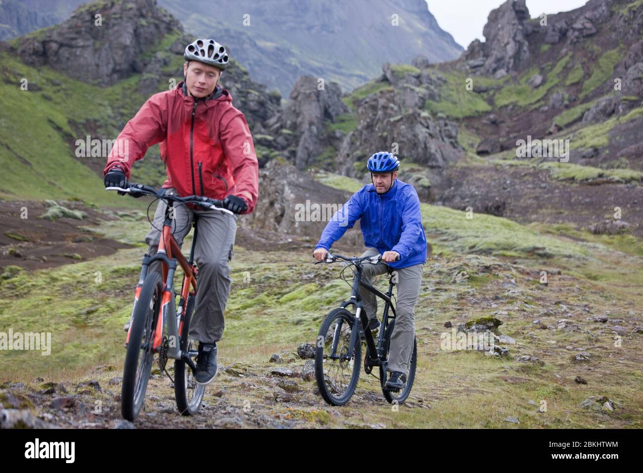 two friends riding their mountain bikes around Lake Thingvellir Stock ...