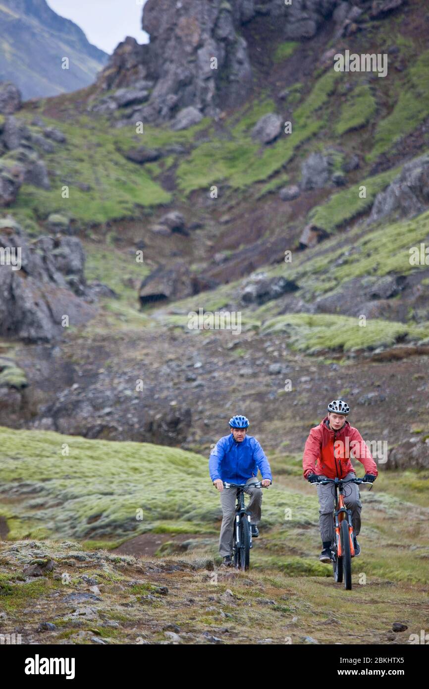 two friends riding their mountain bikes around Lake Thingvellir Stock ...