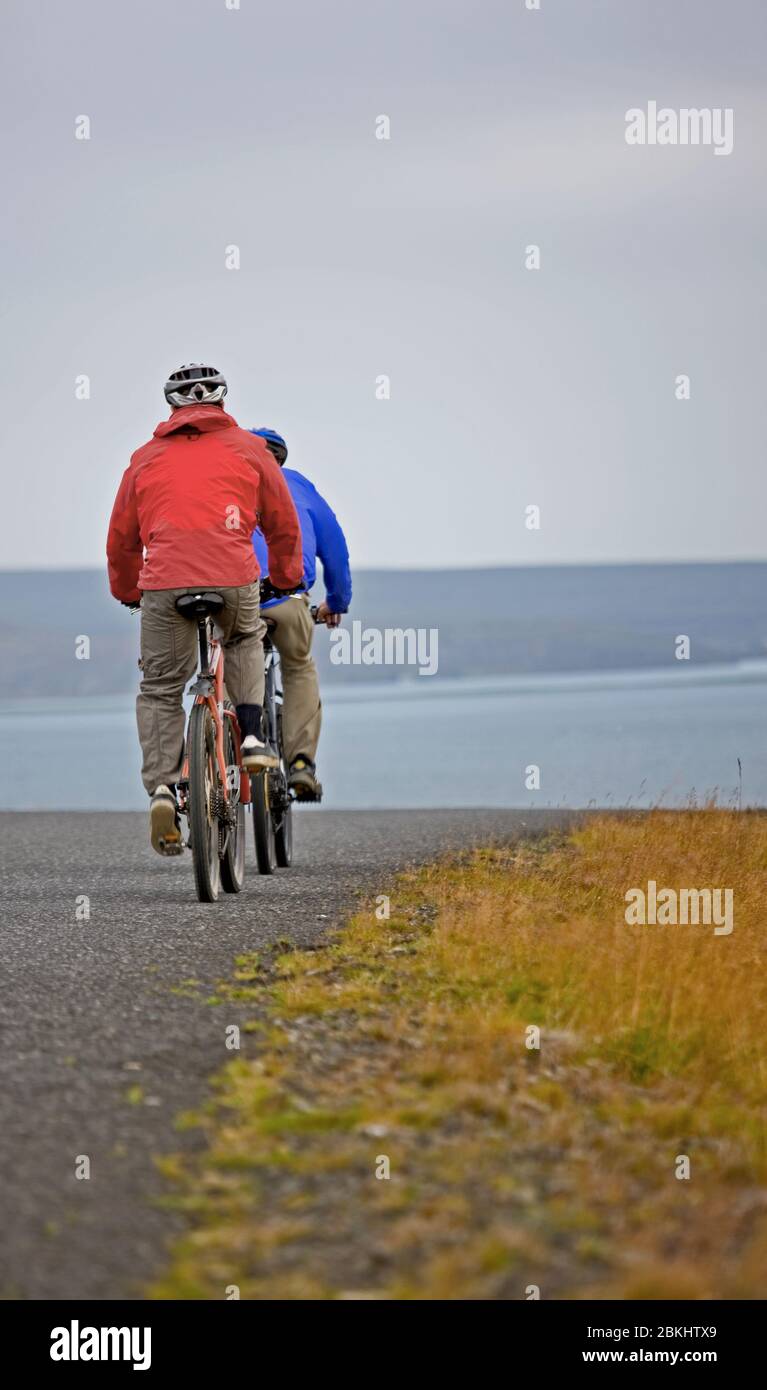 two friends riding their mountain bikes around Lake Thingvellir Stock ...