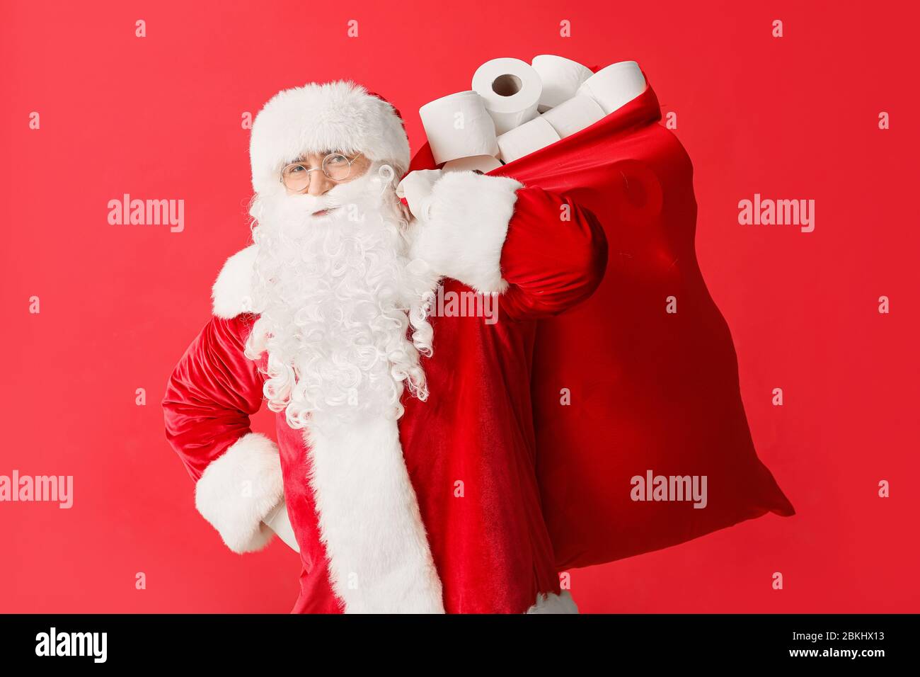 Santa Claus with toilet paper in bag on color background. Concept of ...