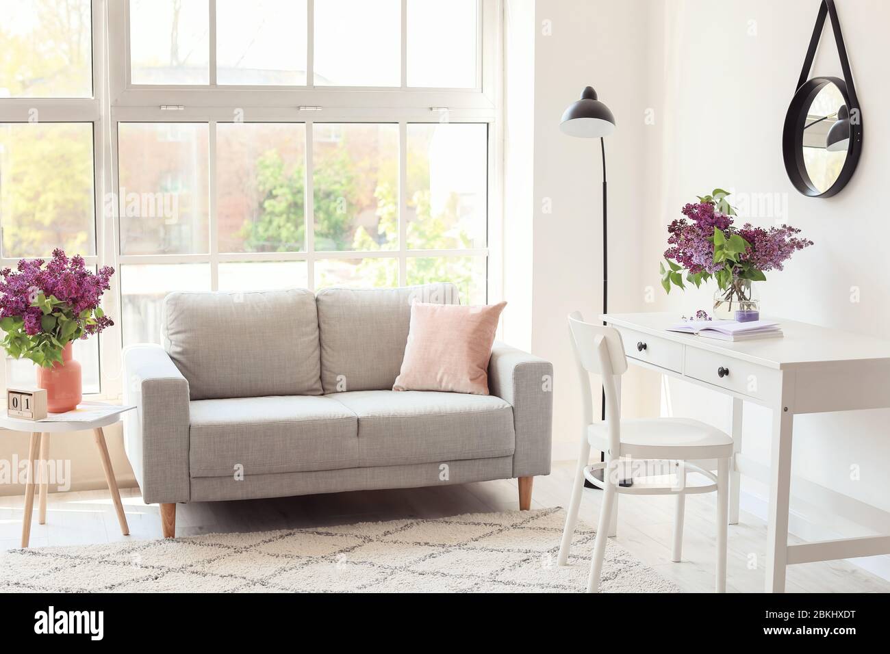 Interior of living room with spring flowers Stock Photo - Alamy