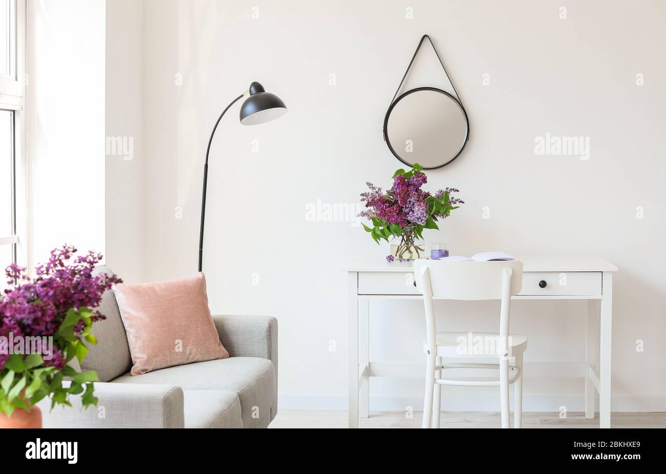 Interior of living room with spring flowers Stock Photo - Alamy