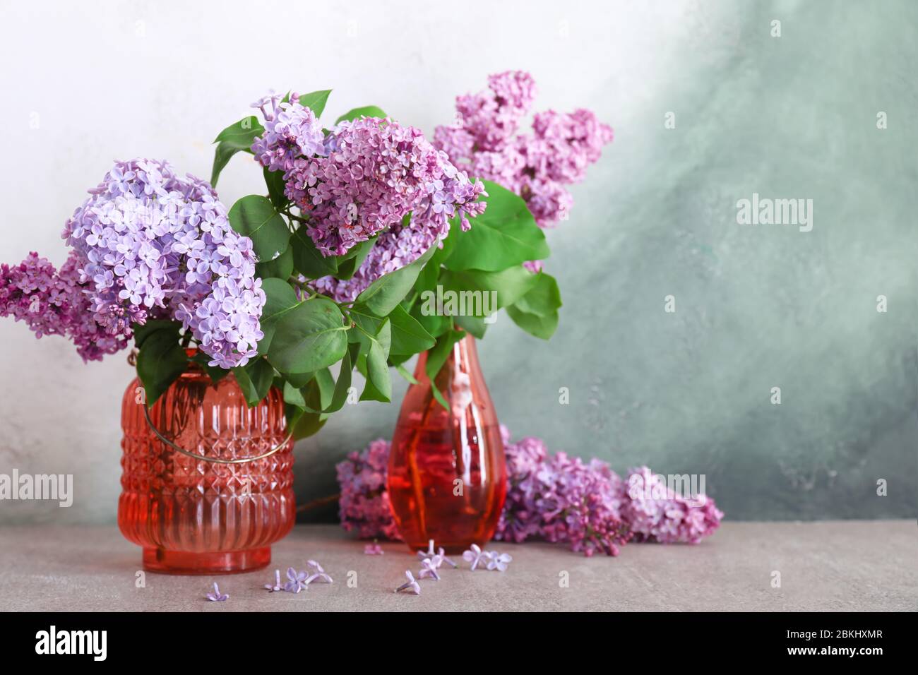 Vases with beautiful lilac flowers on table Stock Photo - Alamy