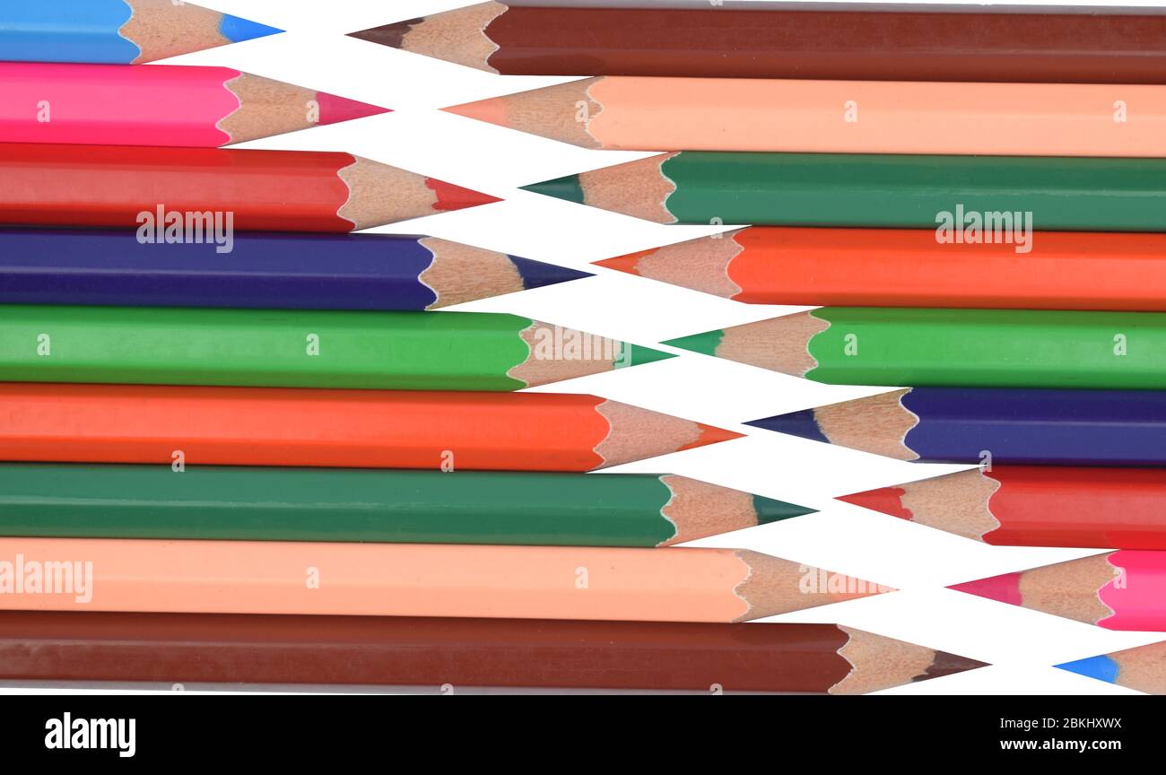 Two rows of different color wood pencil crayons facing each other on a ...