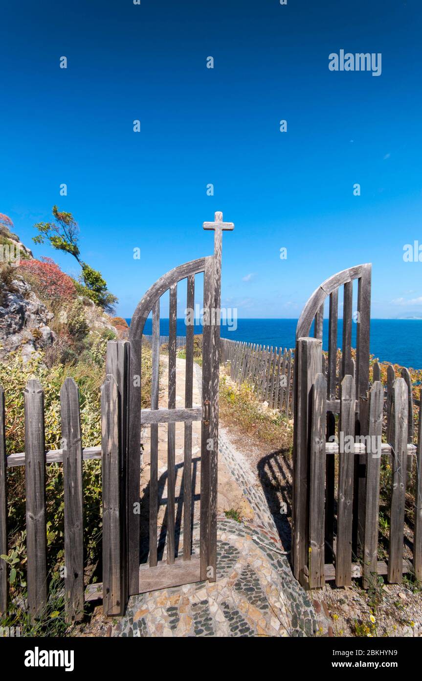 Cliff way around Kolymvaria, Greece. The narrow path winds along the ...