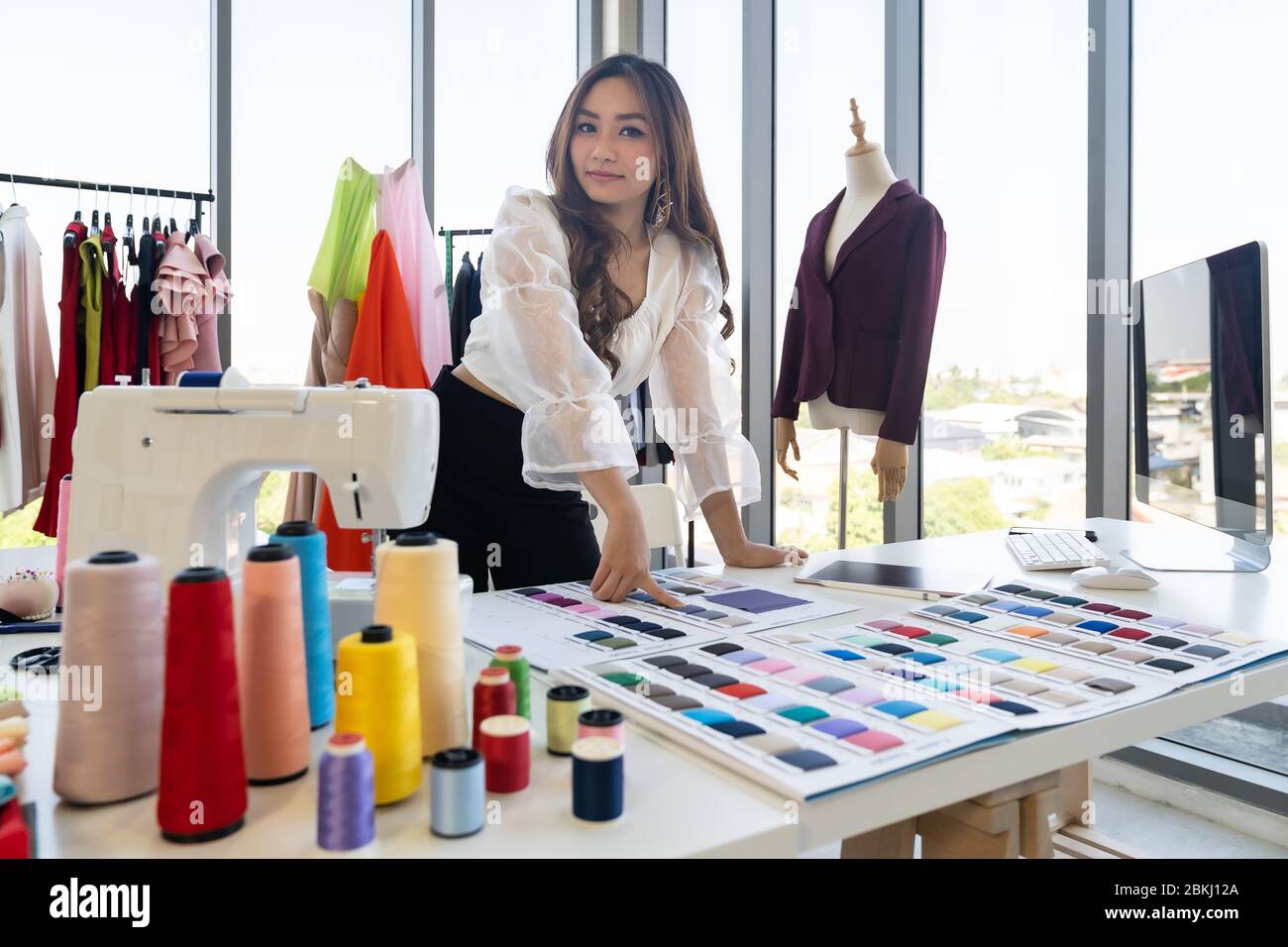 Portrait of young adult asian fashion designer working from home with ...