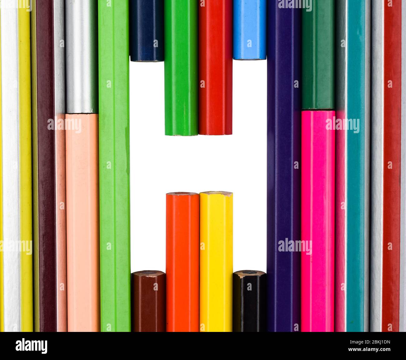 H letter made with a row of different color wood pencil crayons on a ...