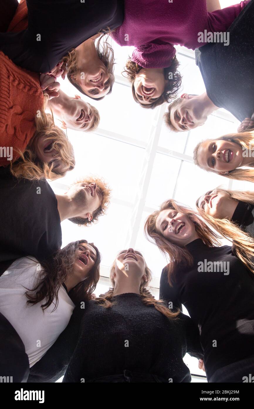 group of happy young people standing in a circle Stock Photo - Alamy