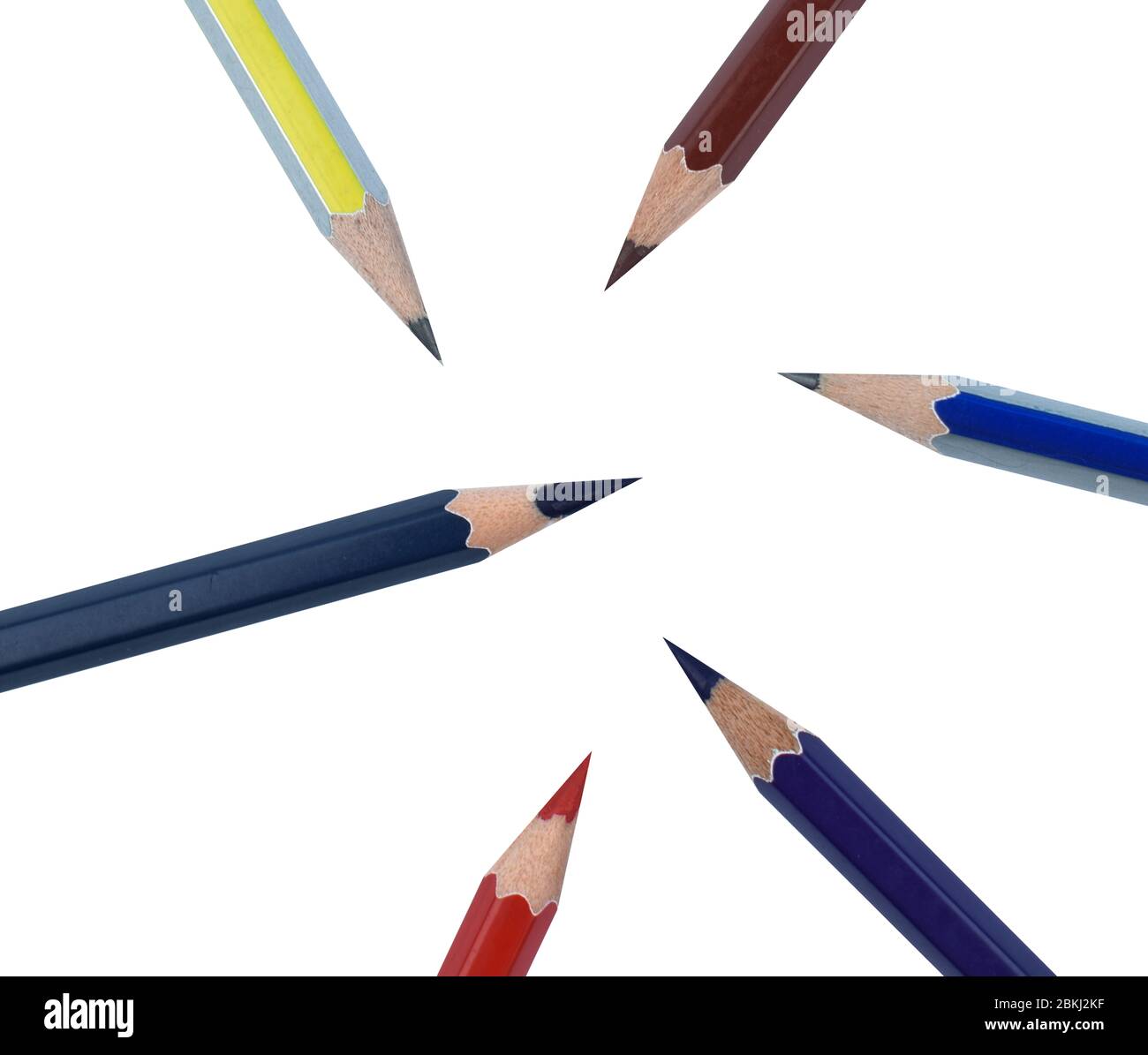 Six different color wood pencil crayons scattered across a white paper ...