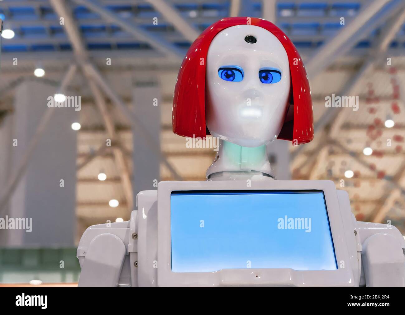 Assistant robot with expressive blue eyes and red hair Stock Photo - Alamy