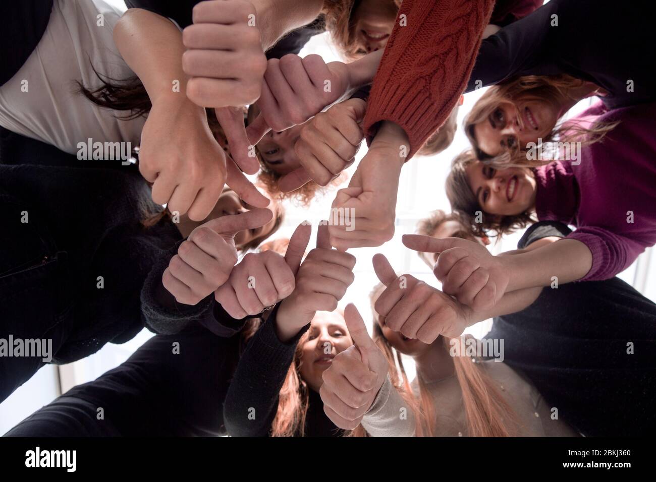 happy young people standing in a circle and showing thumbs up Stock ...