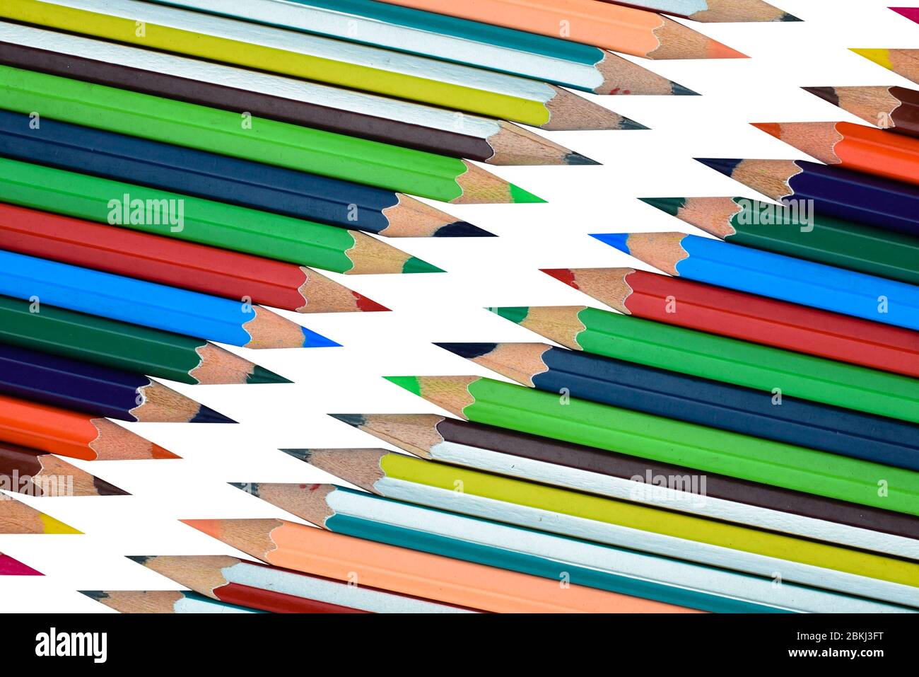 Top view of two rows of different color wood pencil crayons facing each ...