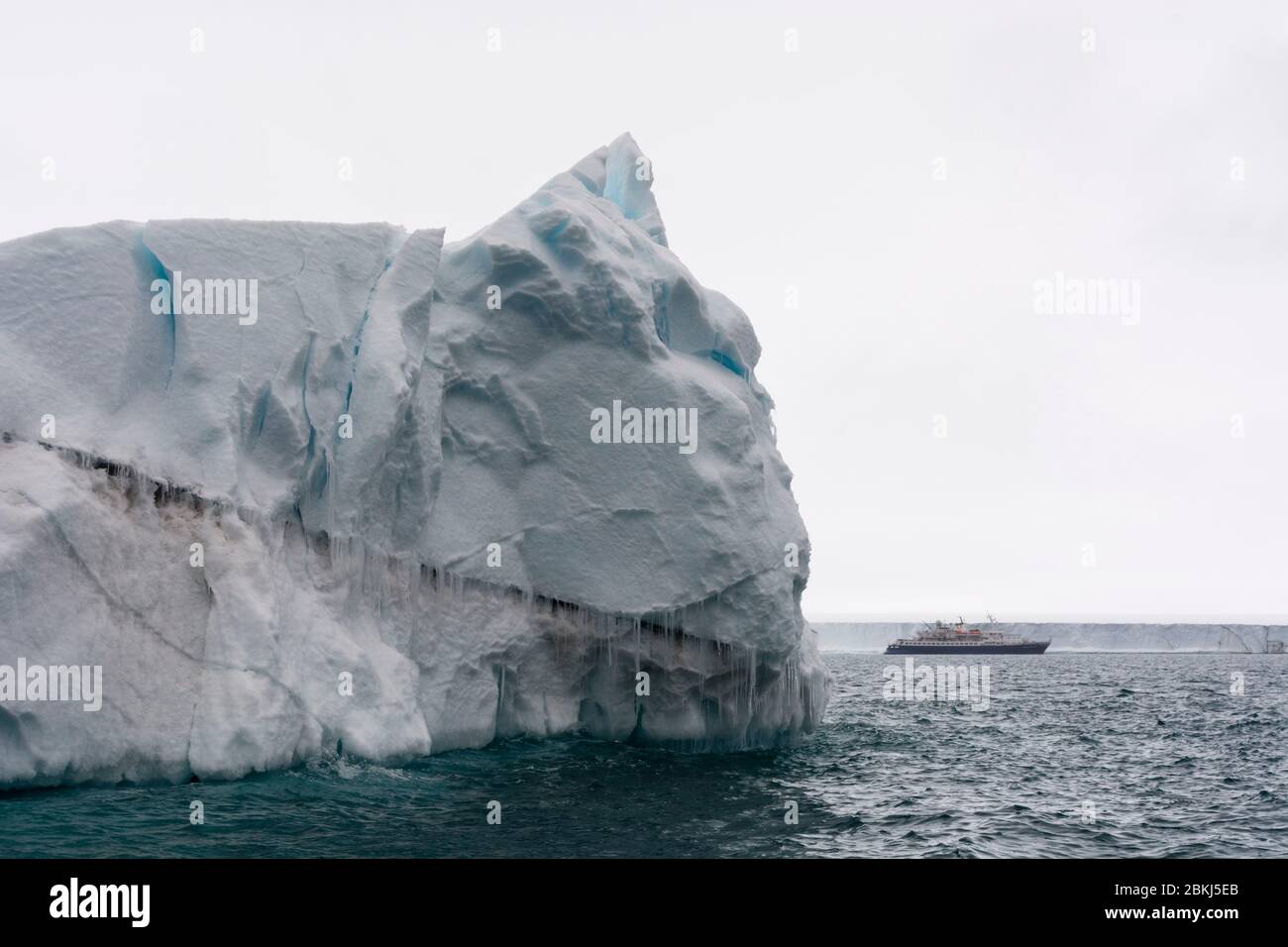 Ocean Adventurer cruise ship, sailing along the cliffs of Austfonna ice ...