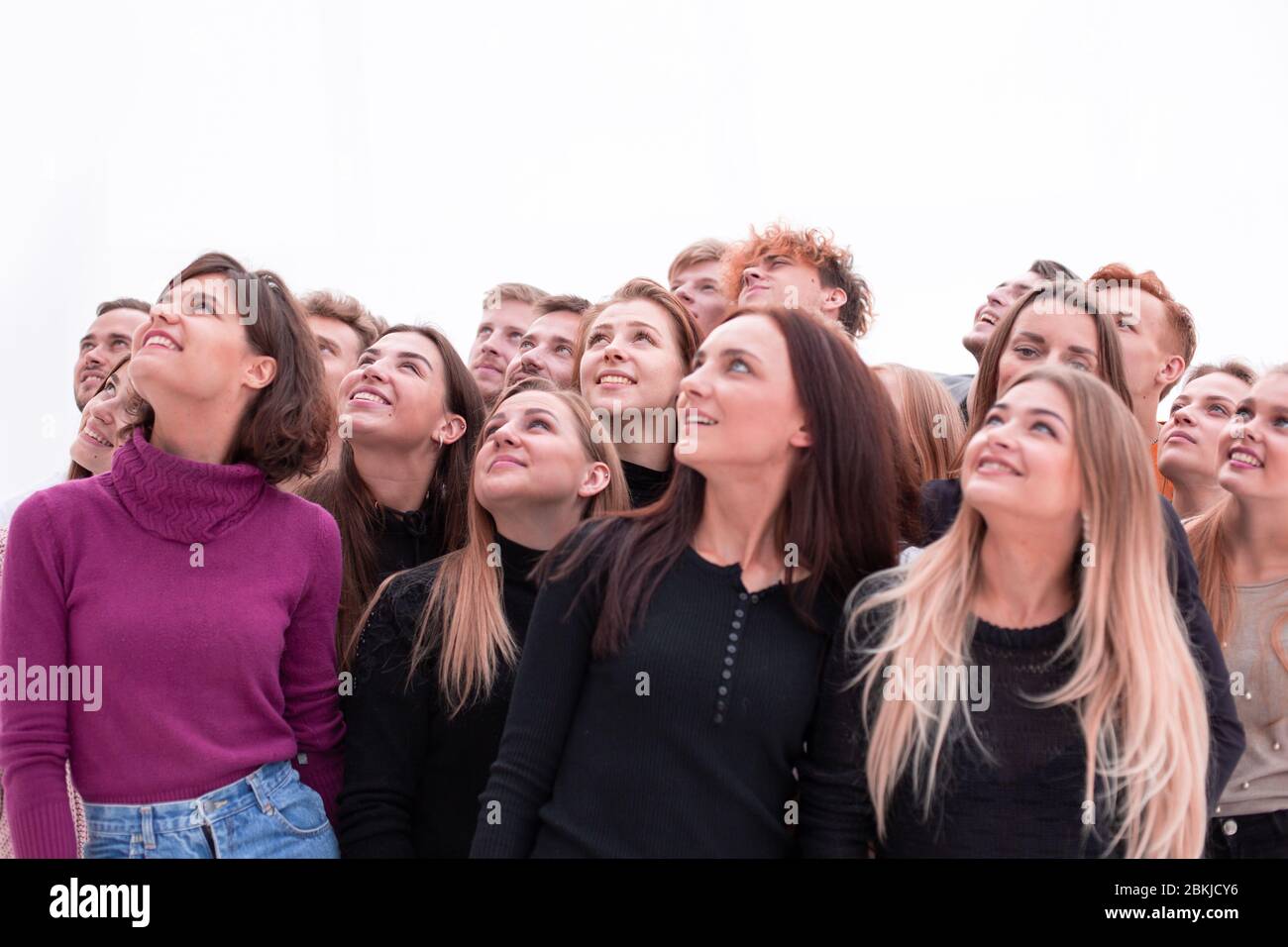 close up. happy young people looking up somewhere Stock Photo - Alamy