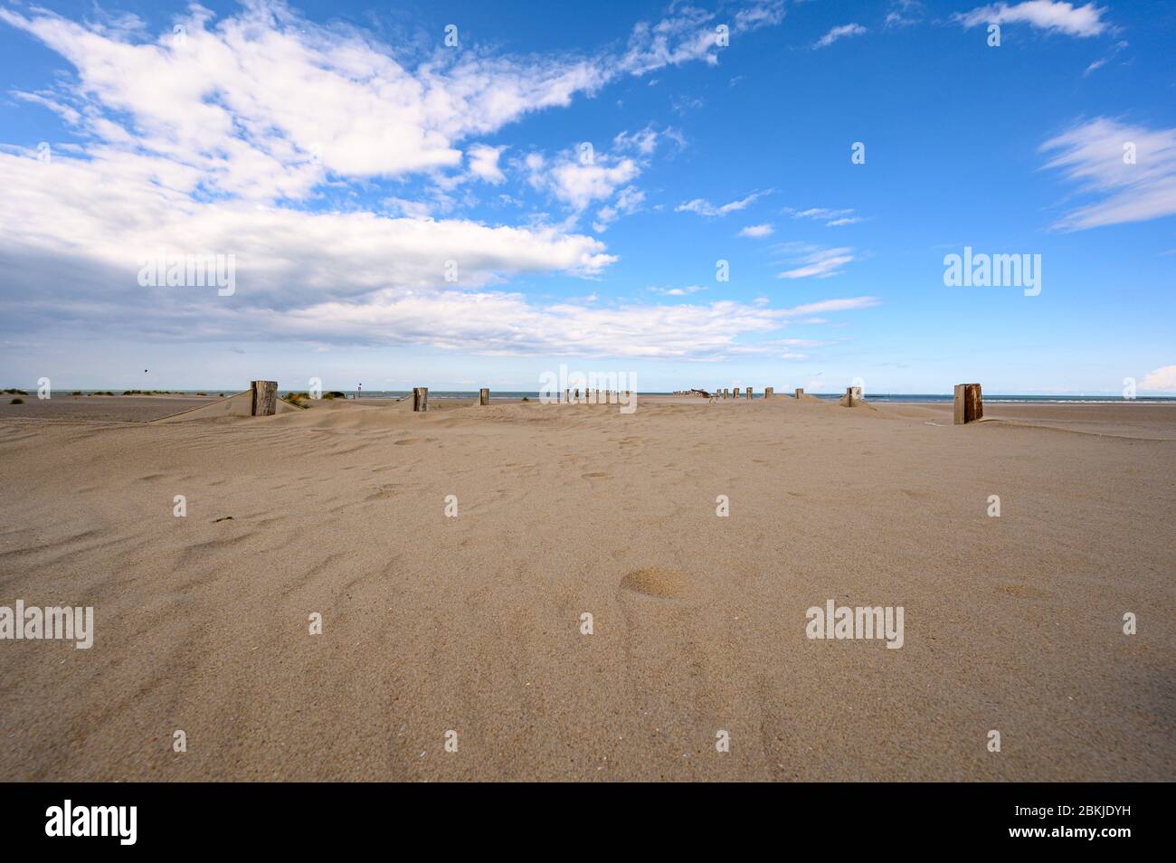 The beach at Dunkirk with wooden poles of the sea defences and white ...