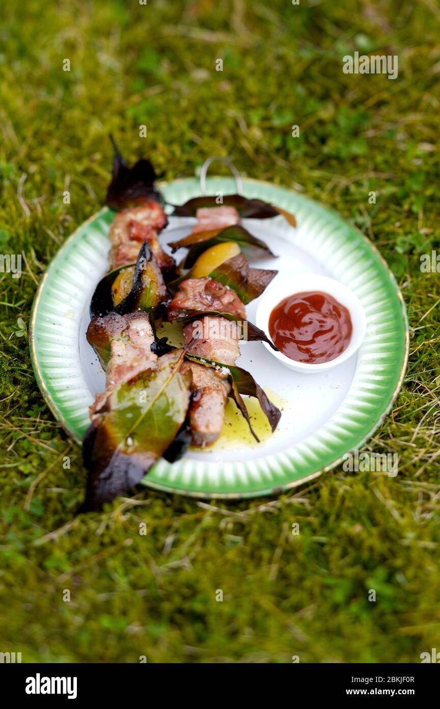 Skewer of pork loin with candied lemon barbecue sauce Stock Photo - Alamy