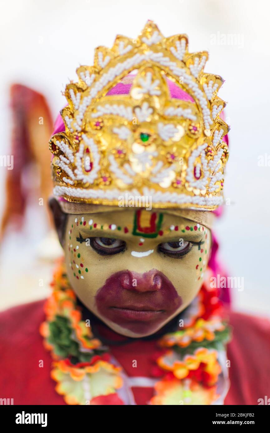 India, Rajasthan, Udaipur, portrait of a young boy wearing makeup like ...